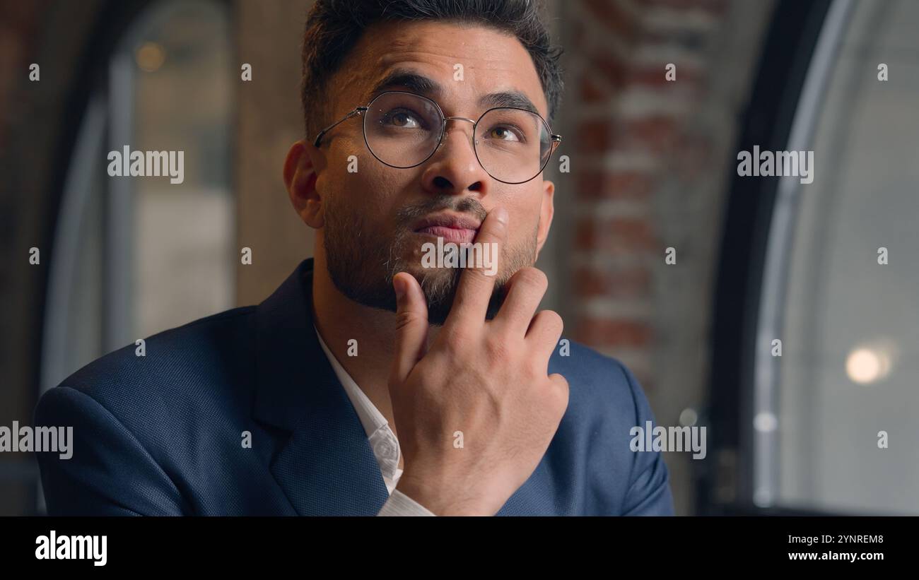Thoughtful puzzled businessman Arabian Indian man thinking male guy ...