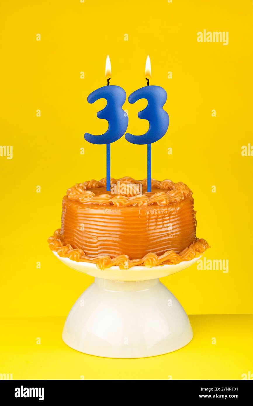 Happy birthday cake with number 33 candle - Card on a yellow background ...