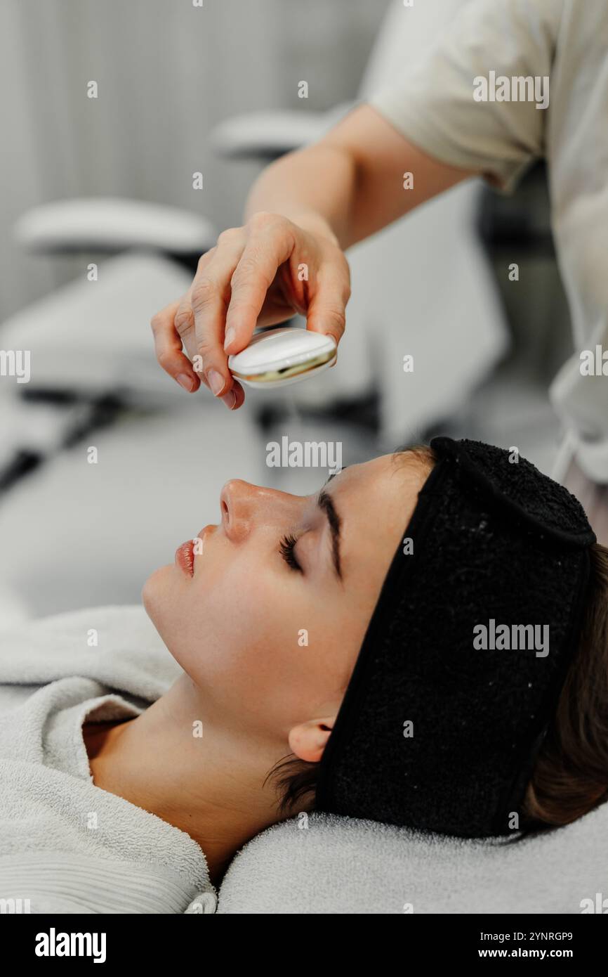 Woman receiving a facial treatment in a serene spa setting during the ...