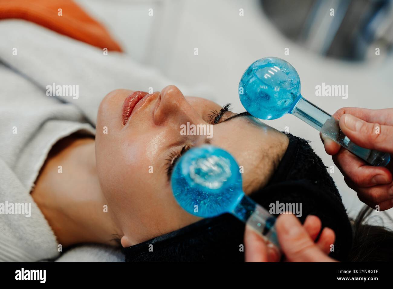 Relaxing facial treatment with cooling tools in a wellness center Stock ...