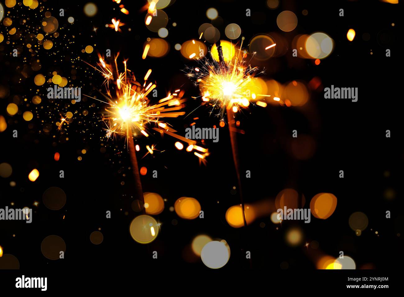 Christmas wallpaper.Sparkling shining fireworks with gold glitter and ...