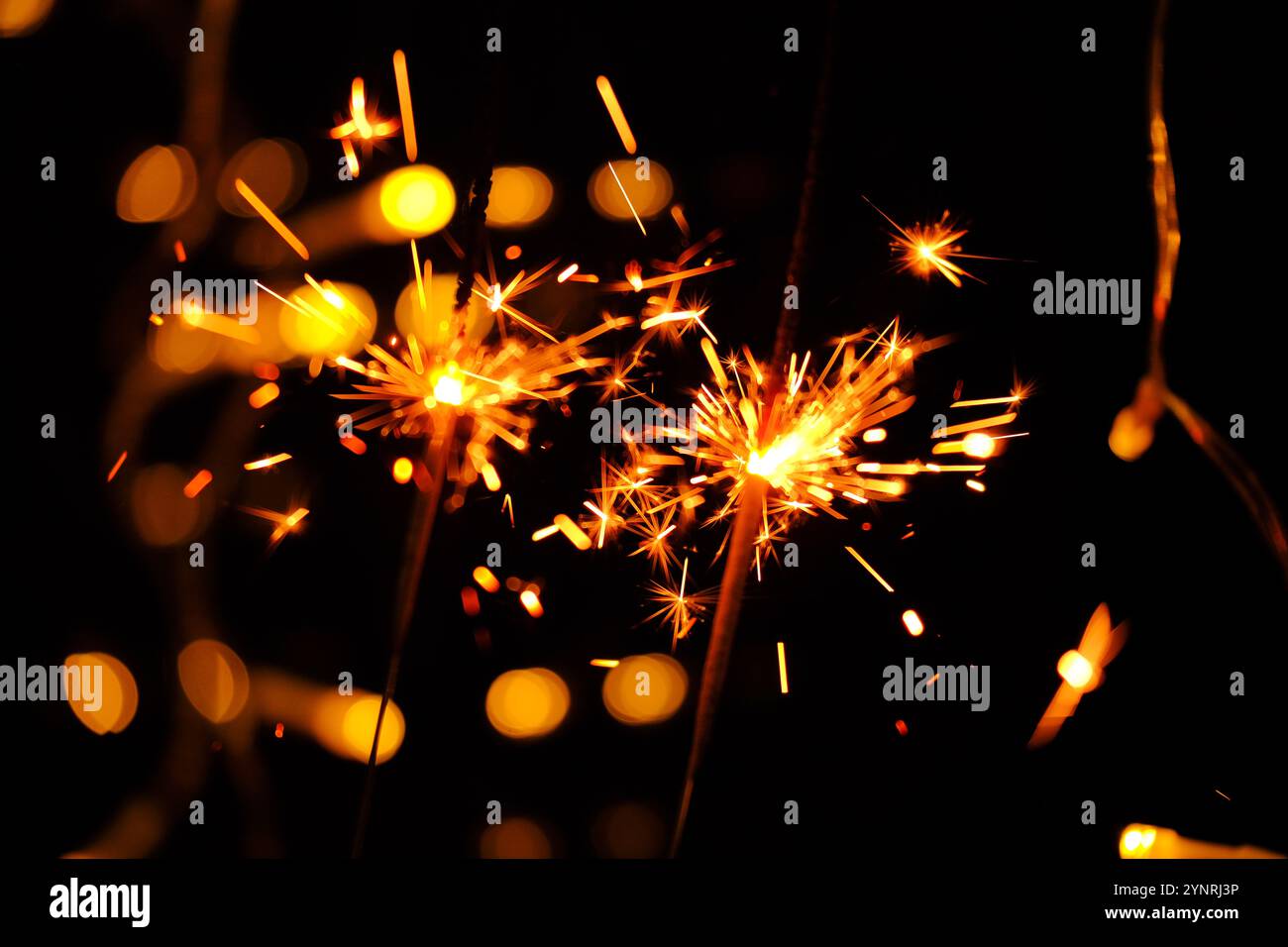 Sparkling shining fireworks with gold glitter and bokeh on black ...