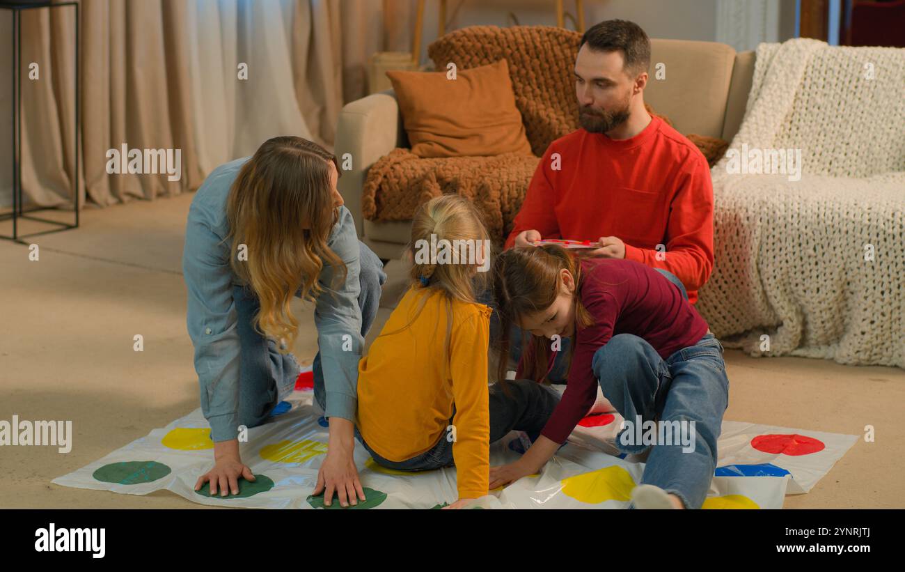 Caucasian happy family parents children playing twister game have fun ...