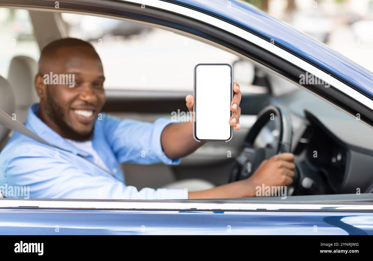 Happy black driver using showing smartphone with empty screen Stock ...