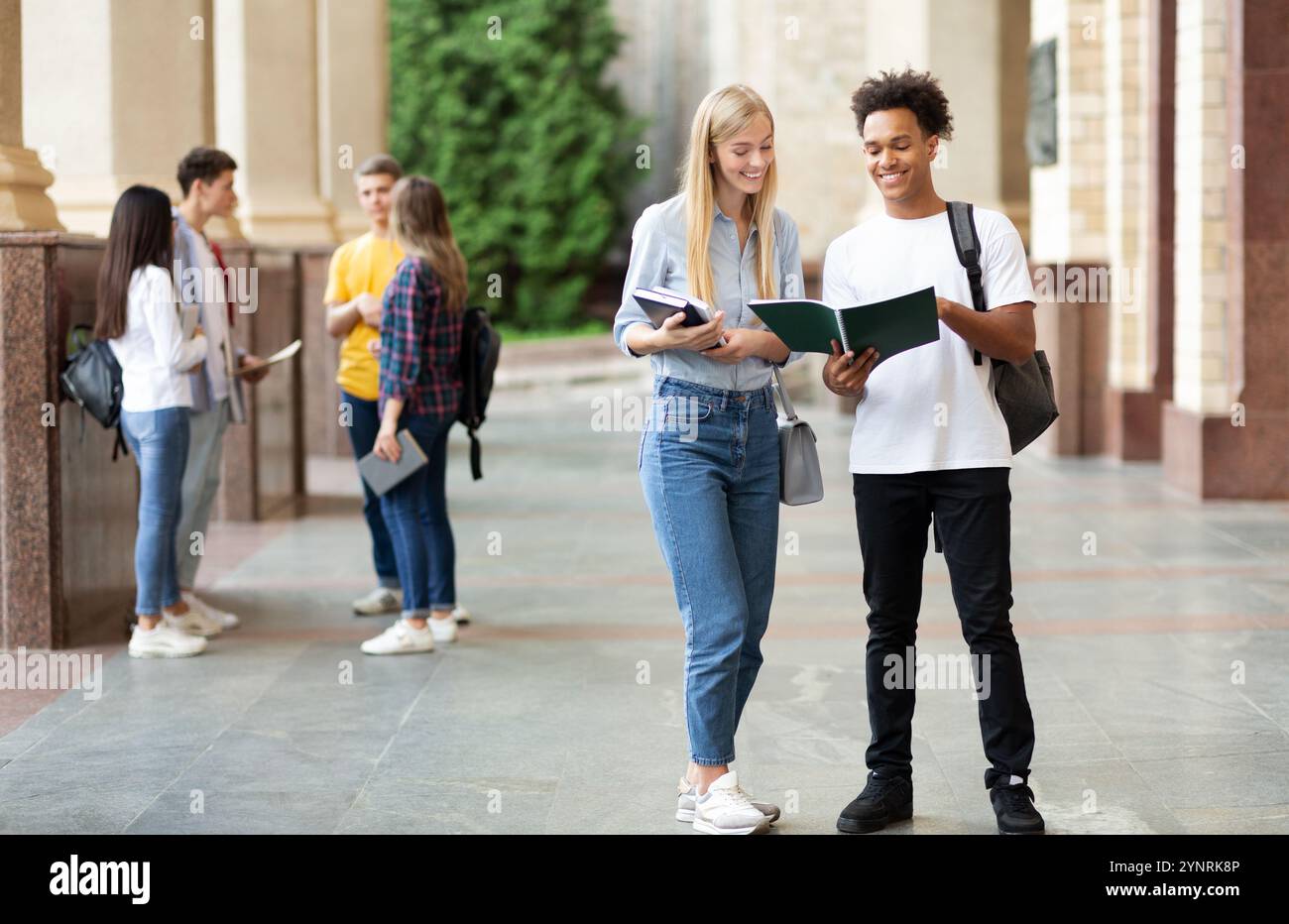 Teens preparing for classes with books in university campus Stock Photo ...