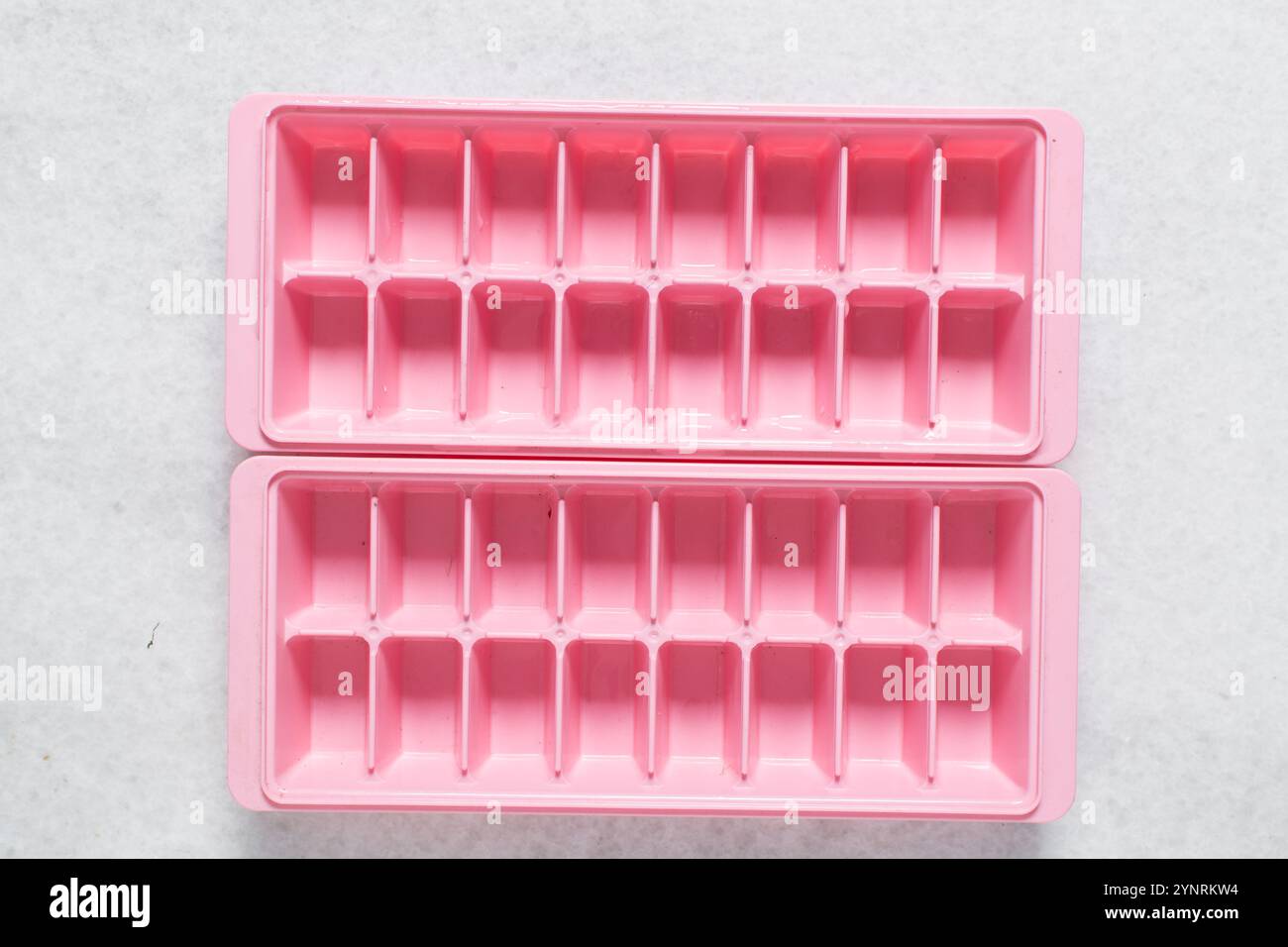Overhead view of pink ice cube tray with a lid, top view of trendy pink ...
