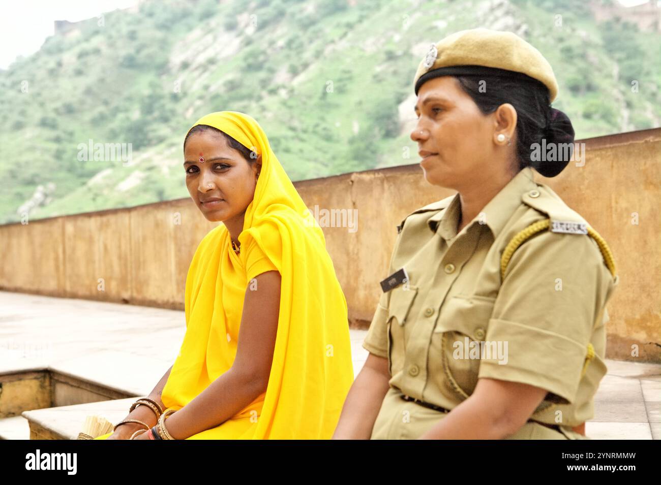 Portrait of women workers, a janitor and a security officer, sitting ...