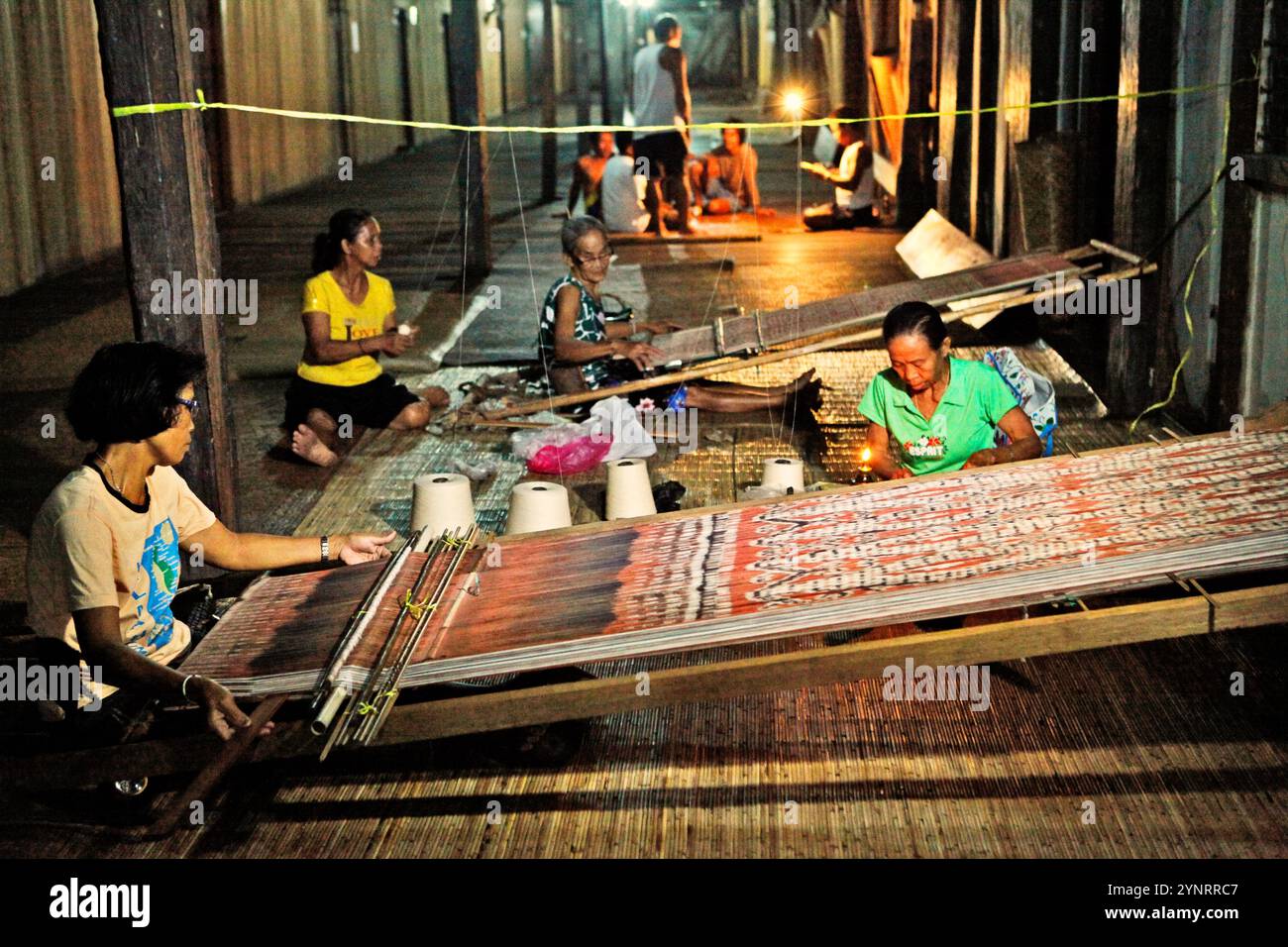 A woman weaving a traditional woven fabric at the longhouse of ...