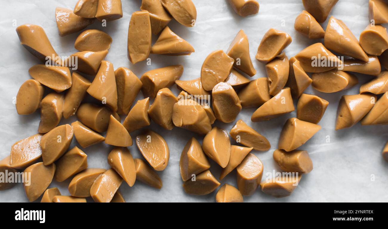 Overhead view of iloka candy on parchment paper, cooked condensed milk ...