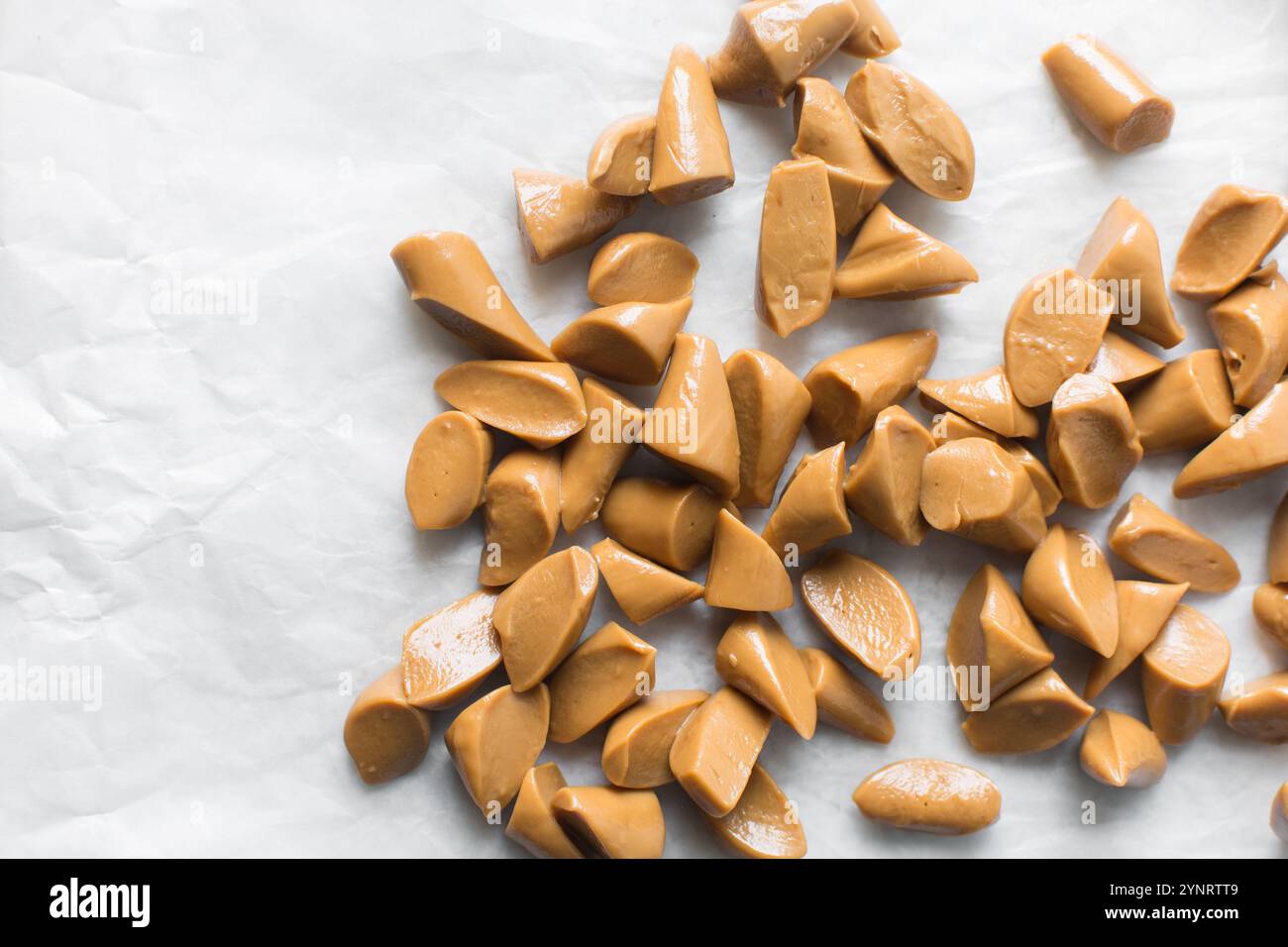 Overhead view of iloka candy on parchment paper, cooked condensed milk ...