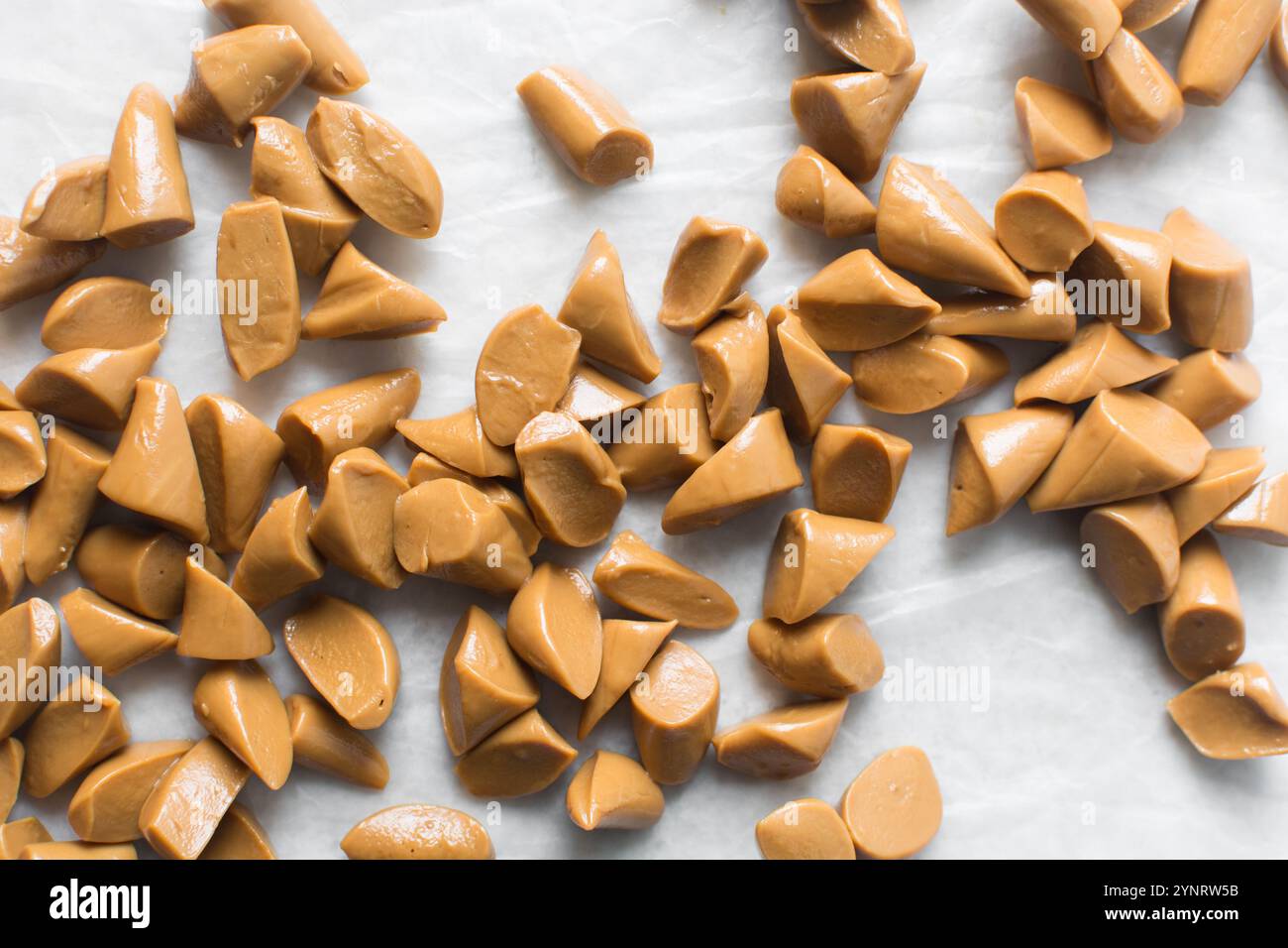 Overhead view of iloka candy on parchment paper, cooked condensed milk ...