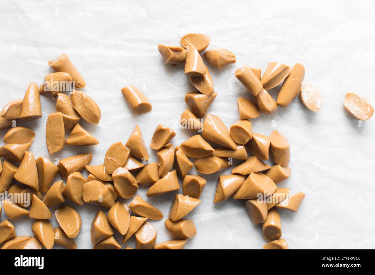 Overhead view of iloka candy on parchment paper, cooked condensed milk ...