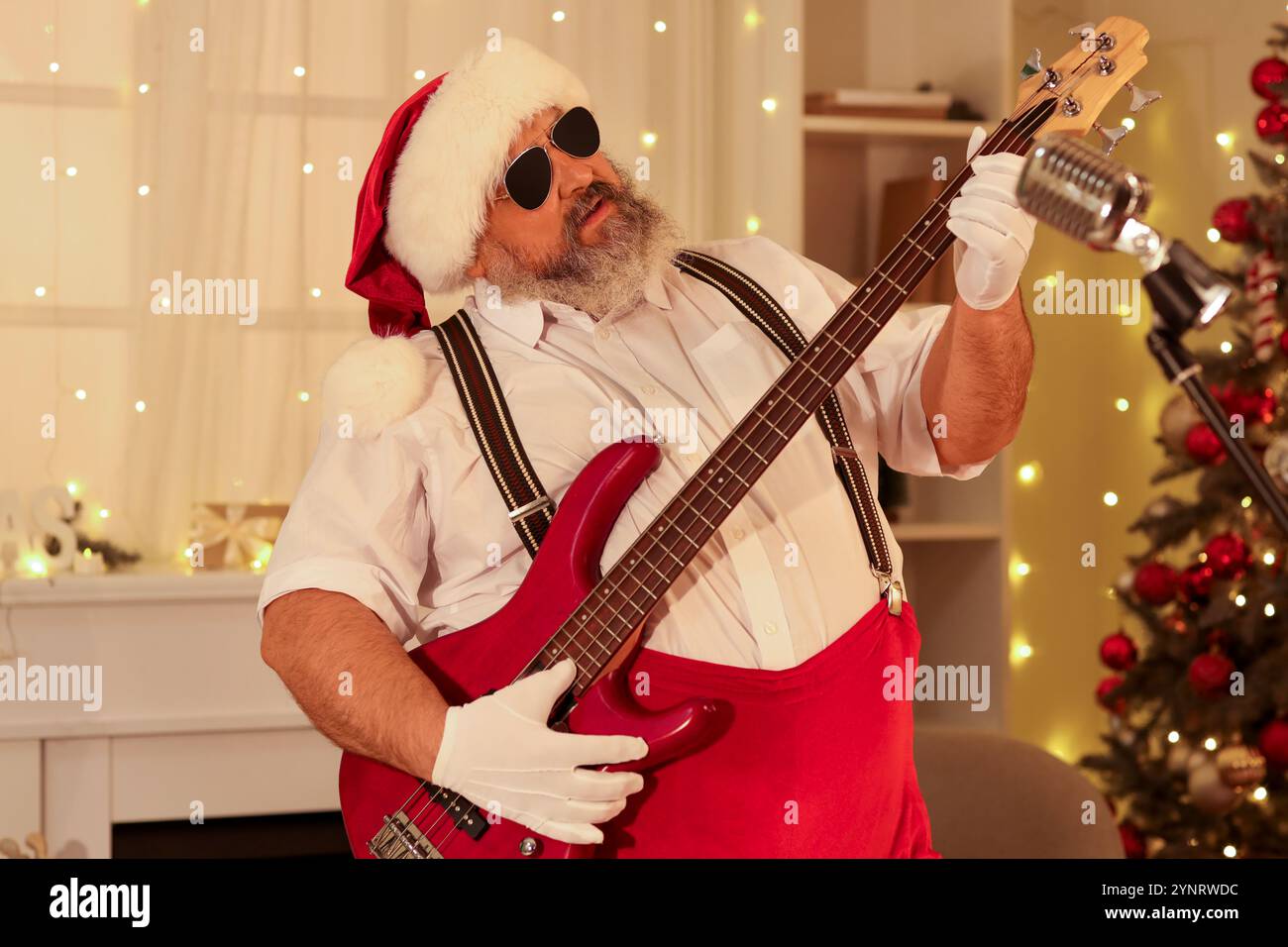 Cool Santa Claus playing guitar at home on Christmas eve Stock Photo ...