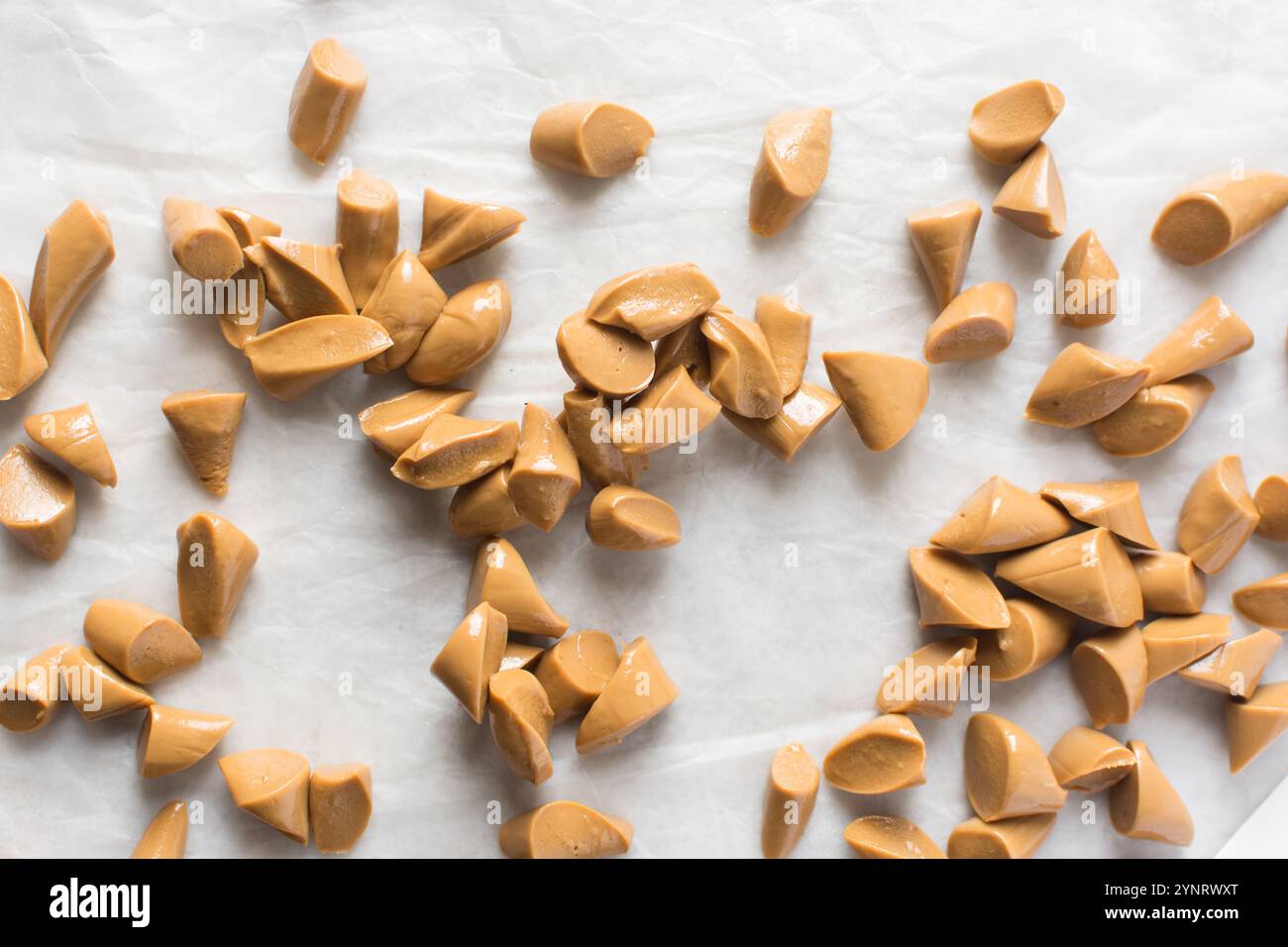 Overhead view of iloka candy on parchment paper, cooked condensed milk ...