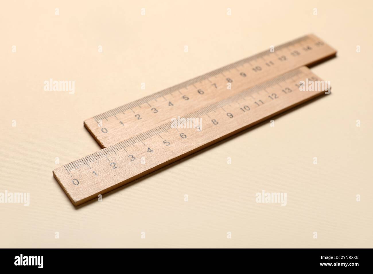 Wooden rulers on color background Stock Photo - Alamy