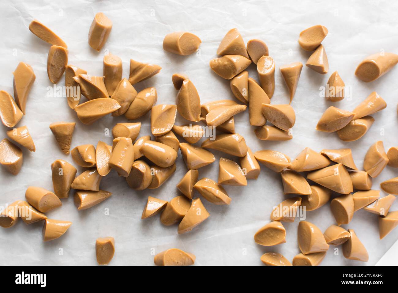Overhead view of iloka candy on parchment paper, cooked condensed milk ...