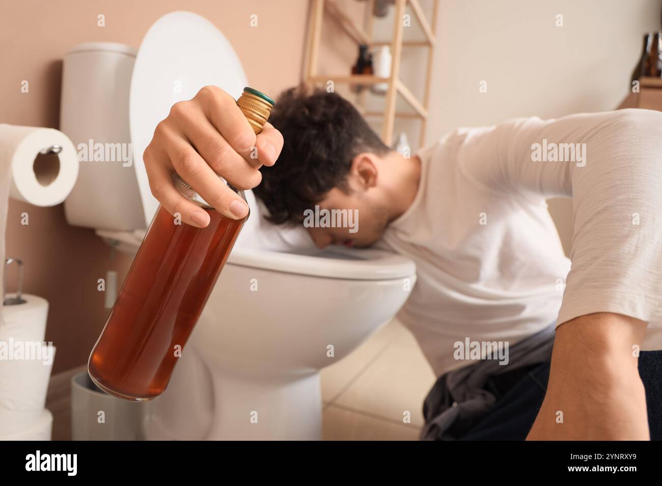 Sick young man with hangover near toilet bowl. Alcoholism concept Stock ...