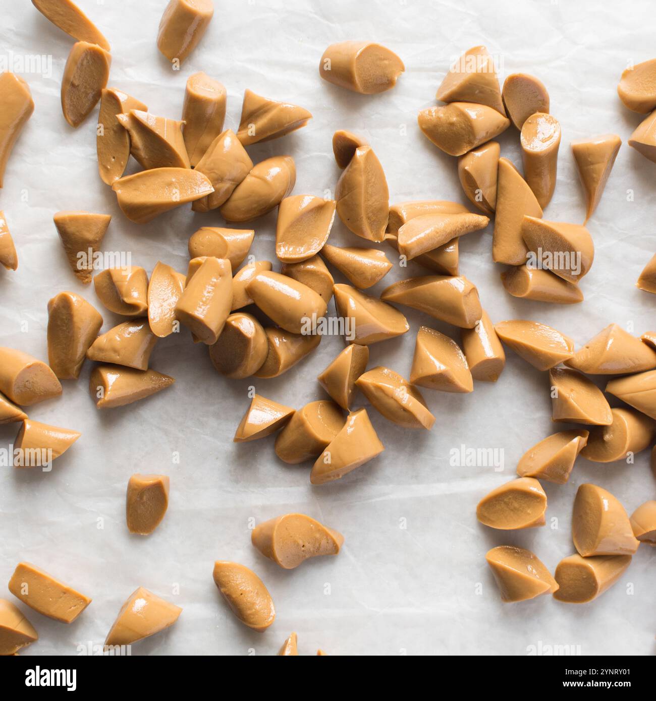 Overhead view of iloka candy on parchment paper, cooked condensed milk ...