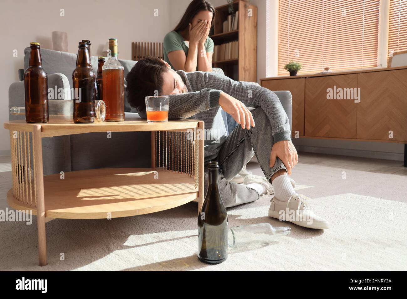 Drunk man and his crying wife at home. Concept of alcoholism Stock ...