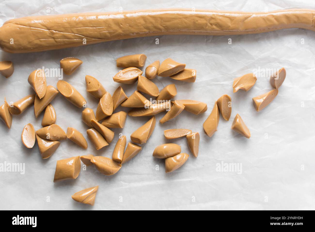 Overhead view of iloka candy on parchment paper, cooked condensed milk ...