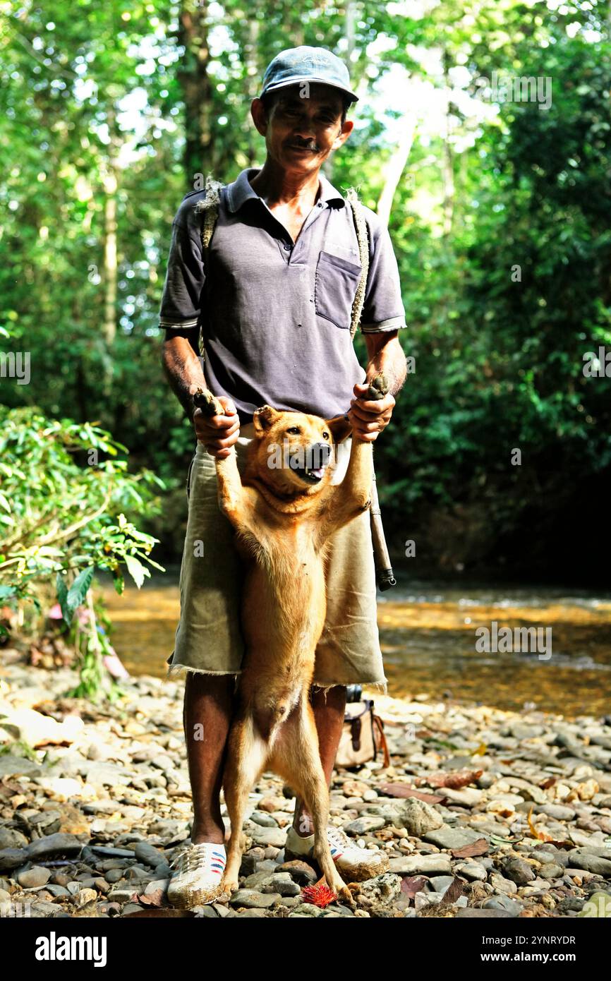 A man is photographed with his dog during a community assignment to ...