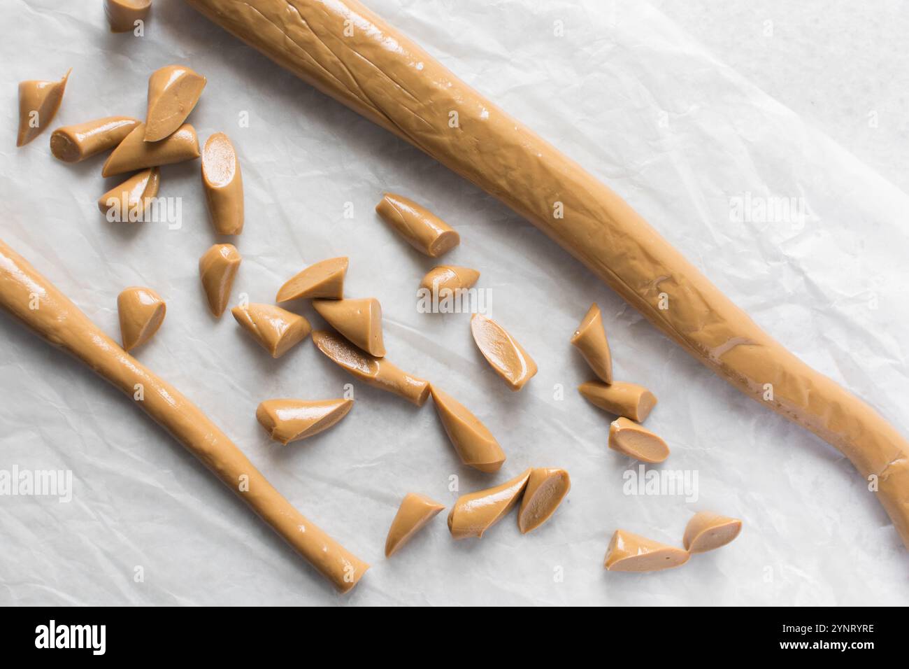 Overhead view of iloka candy on parchment paper, cooked condensed milk ...
