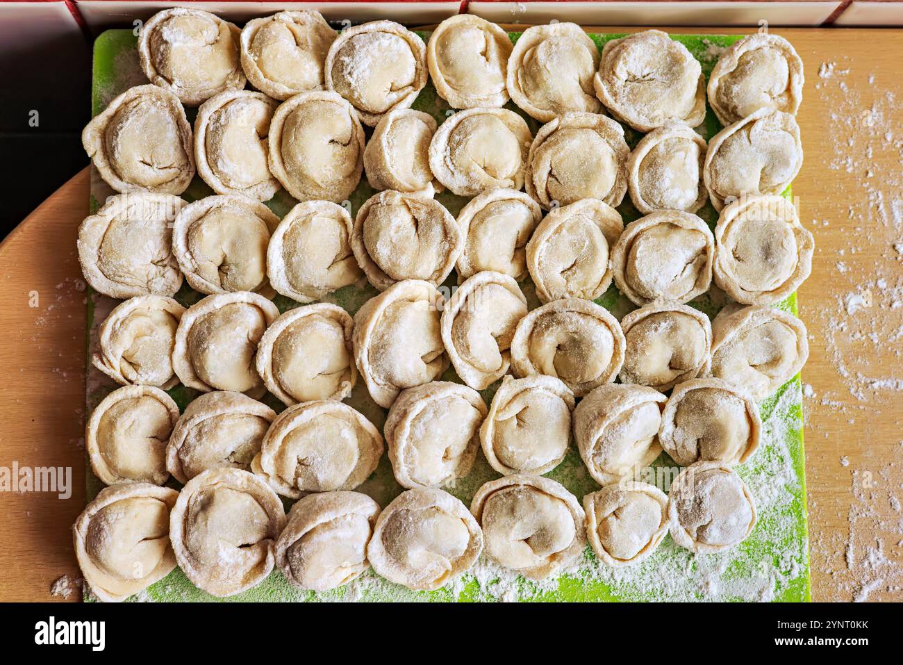 Handmade homemade dumplings stacked in rows on a tray Stock Photo - Alamy
