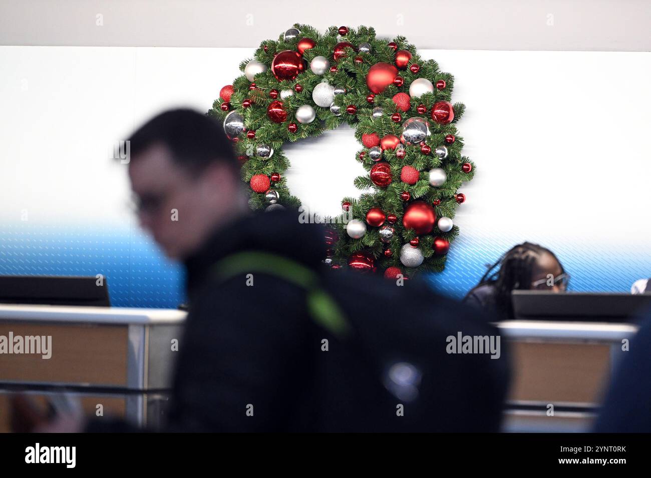 New York, USA. 26th Nov, 2024. A passenger wait in line at JFK's ...