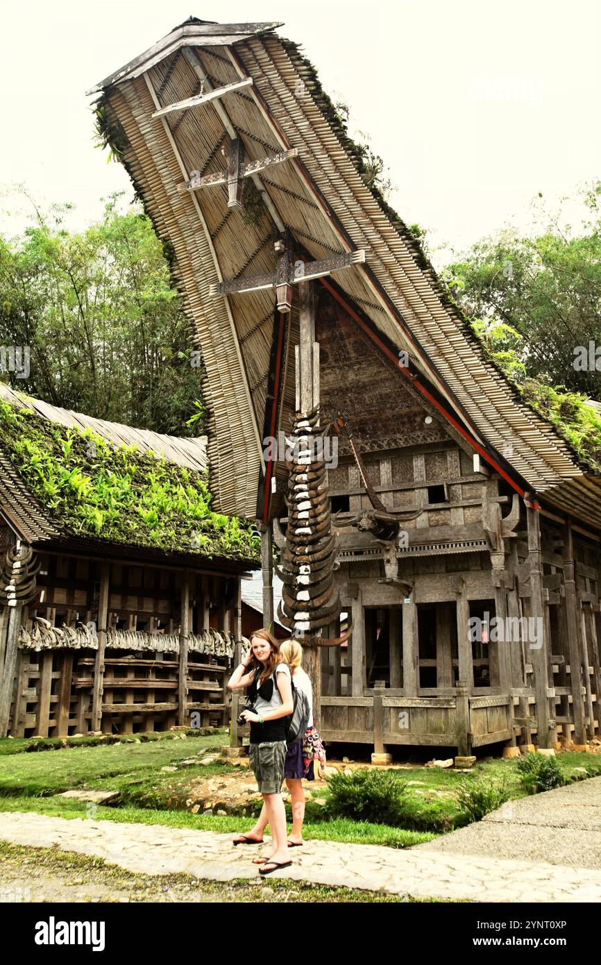 Tourists visiting traditional village of Kete Kesu in Tana Toraja ...