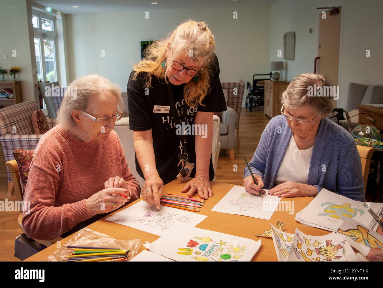 Care home residents colouring in Stock Photo - Alamy