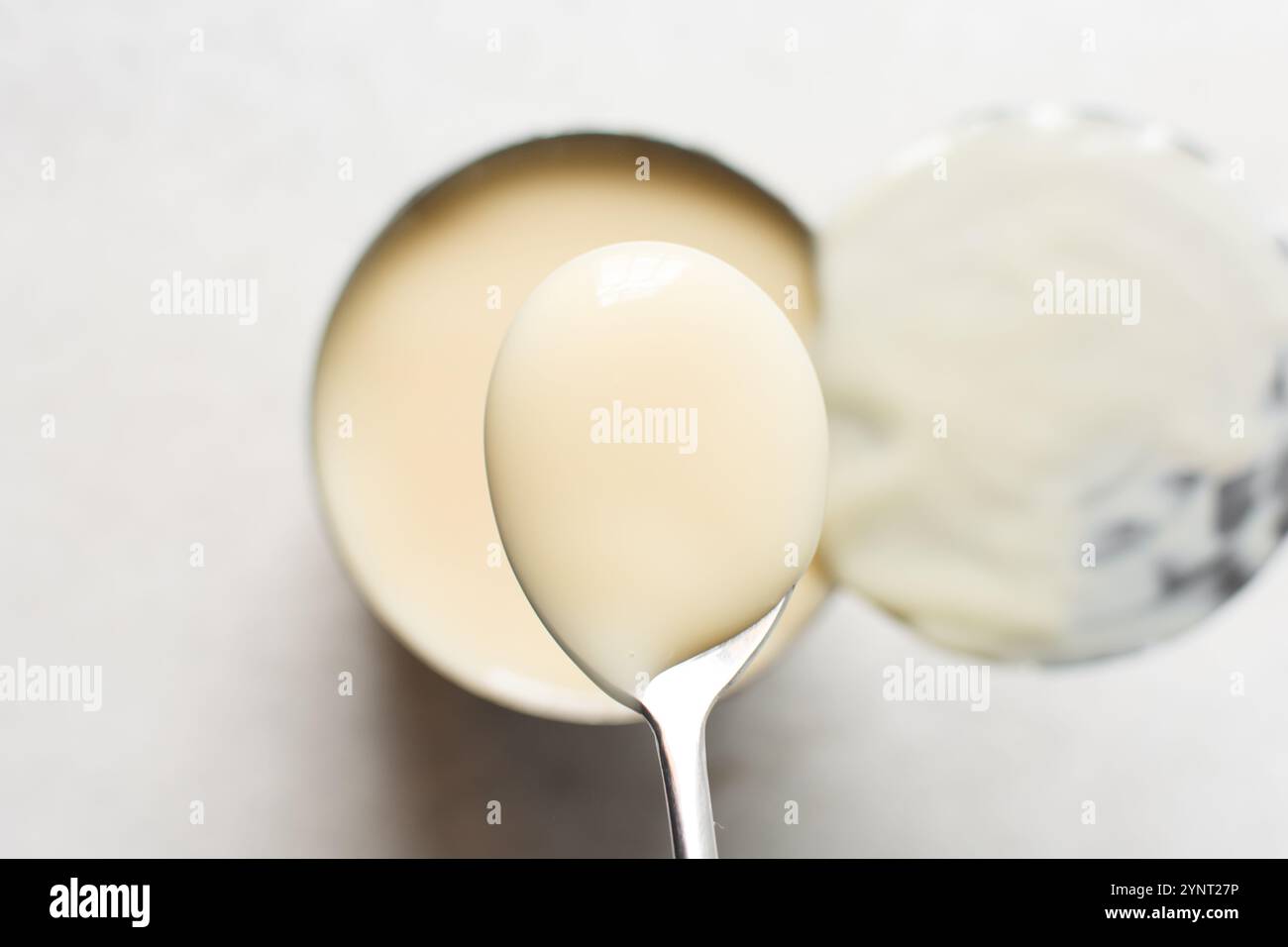 Overhead view of an opened tin of condensed milk with the lid, top view ...