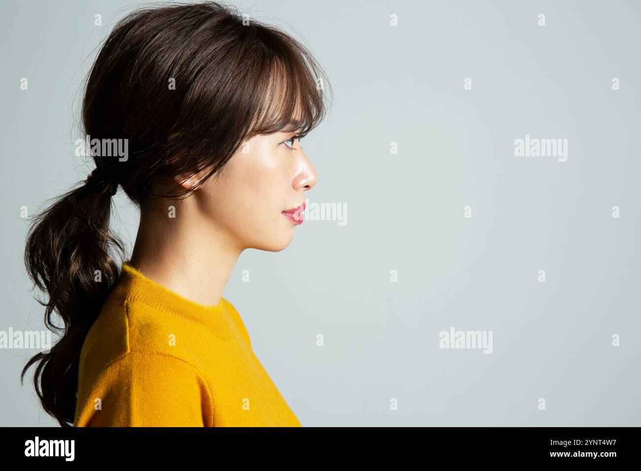 Profile of woman in her 20s with ponytail Stock Photo - Alamy