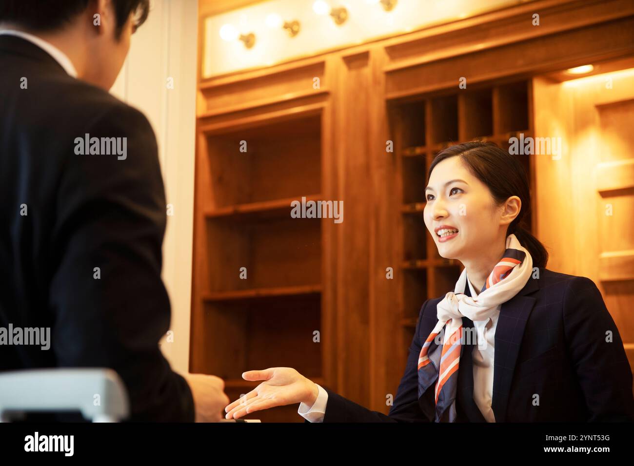 Concierge woman serving customers at the front desk Stock Photo - Alamy