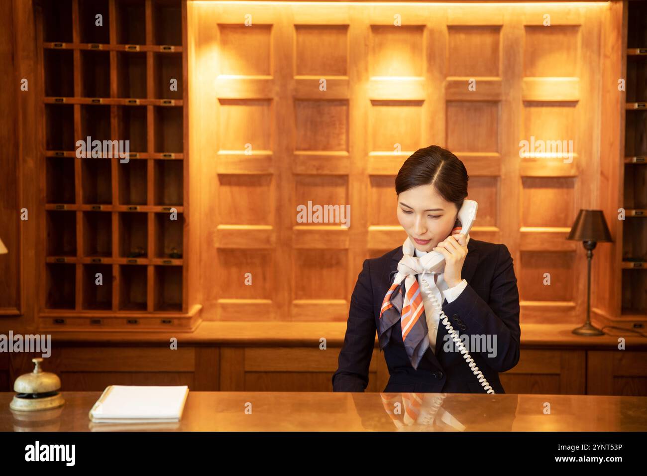 Concierge woman answering the phone Stock Photo - Alamy