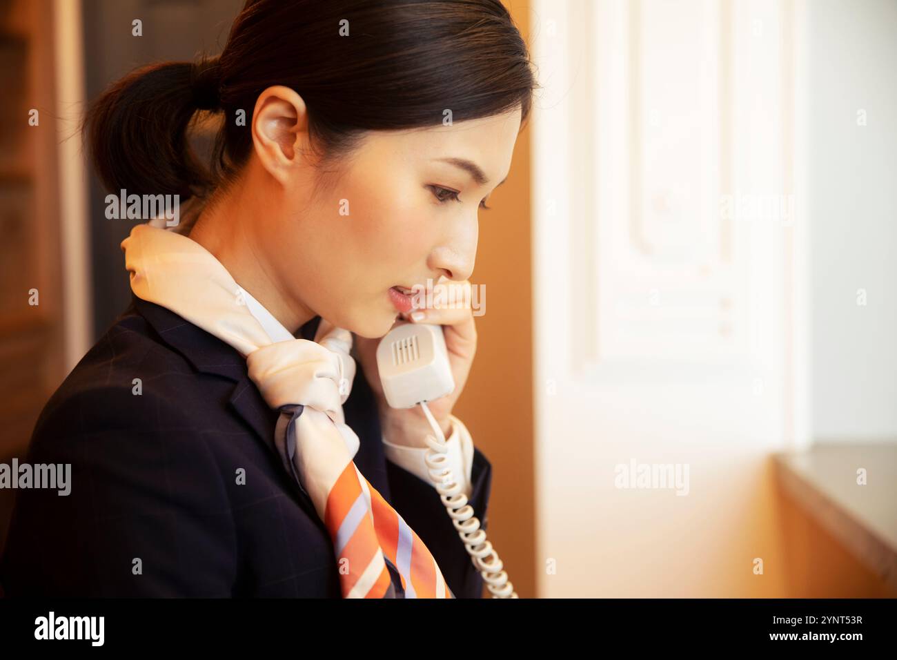Concierge woman answering the phone Stock Photo - Alamy