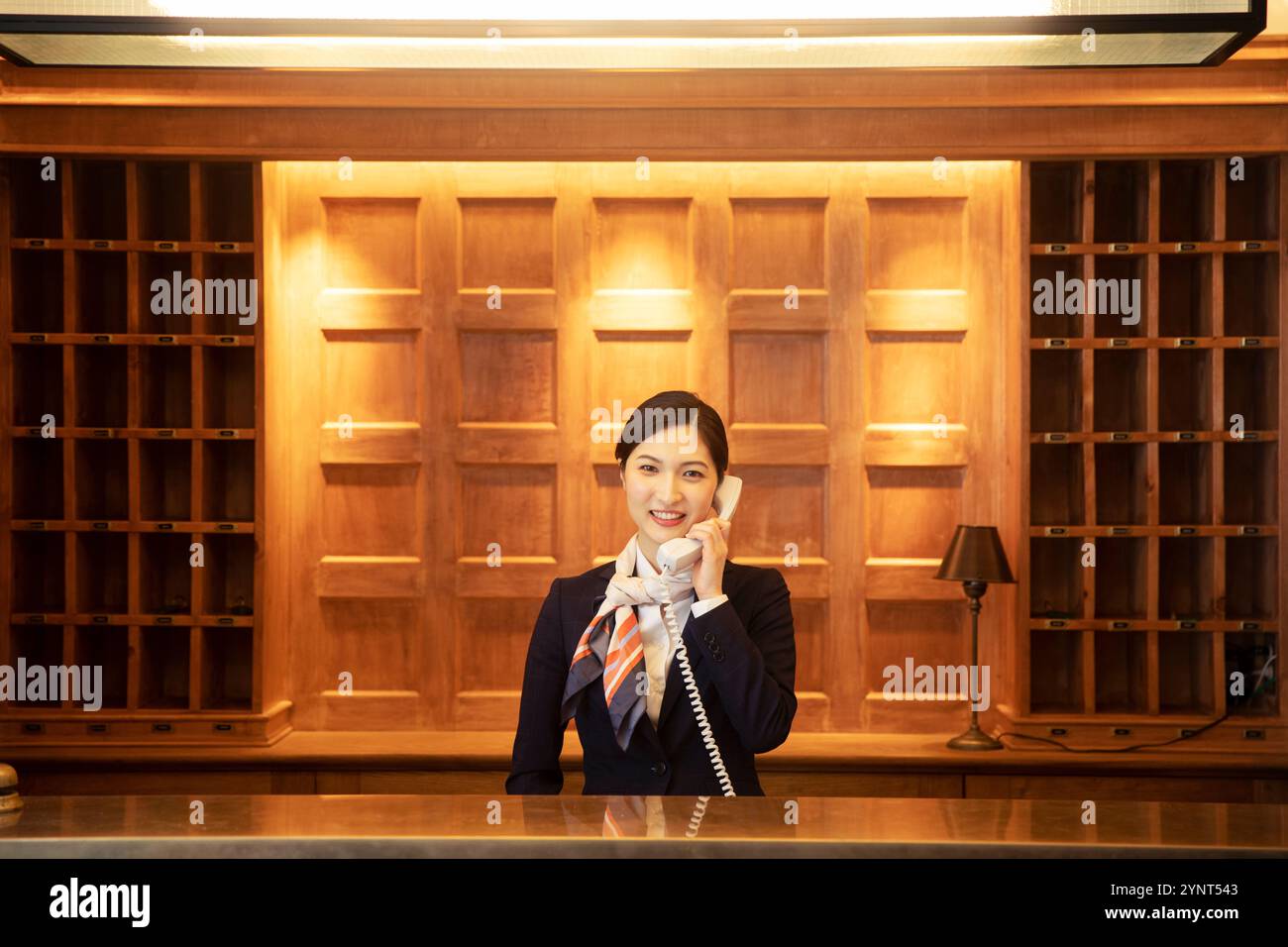 Concierge woman answering the phone Stock Photo - Alamy