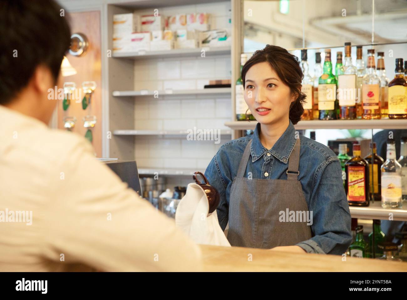 Female waiter and male customer serving customers at café Stock Photo ...