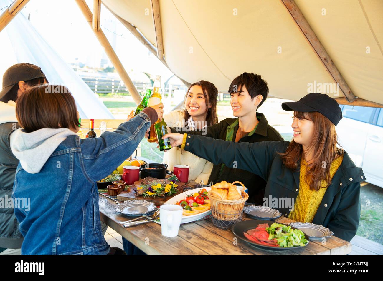 Man and woman in their 20s making a toast over the food Stock Photo - Alamy