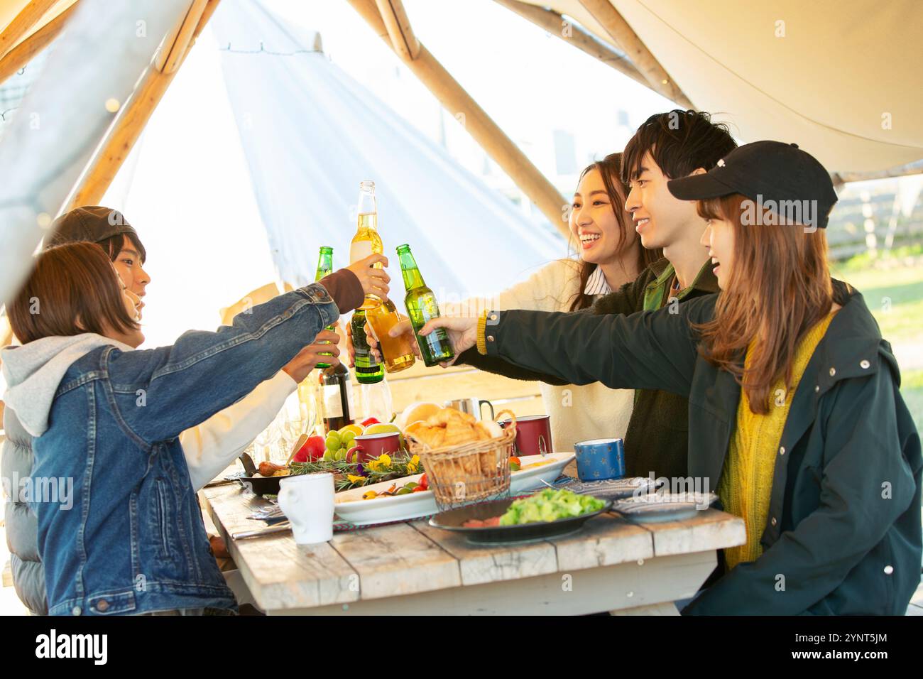 Man and woman in their 20s making a toast over the food Stock Photo - Alamy
