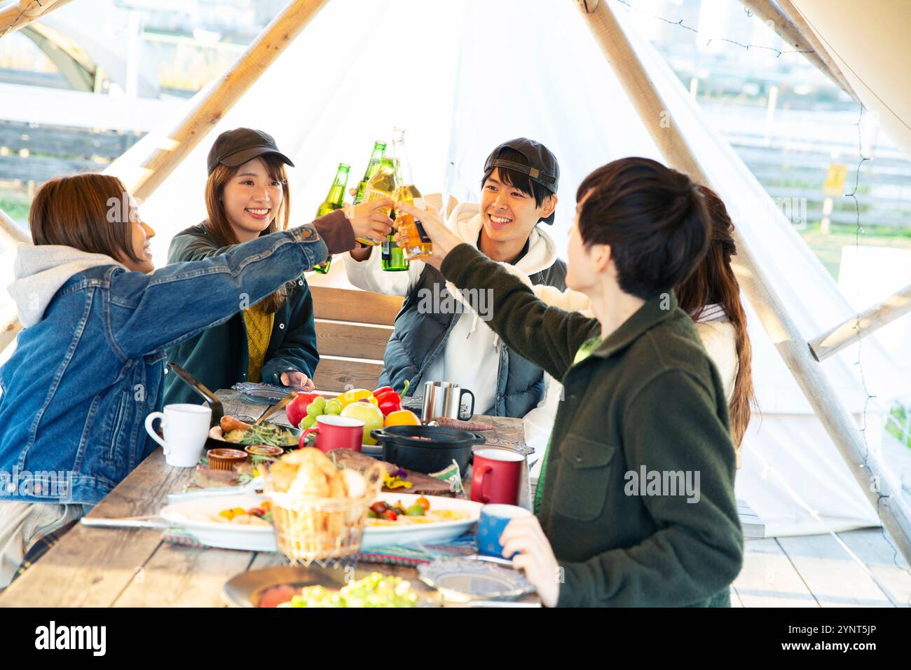 Man and woman in their 20s making a toast over the food Stock Photo - Alamy