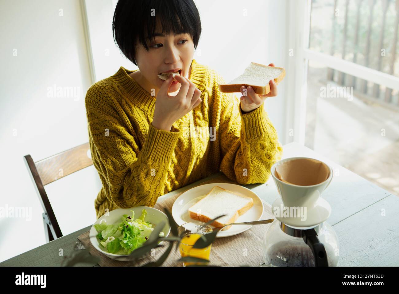 Woman eating bread plain hi-res stock photography and images - Alamy