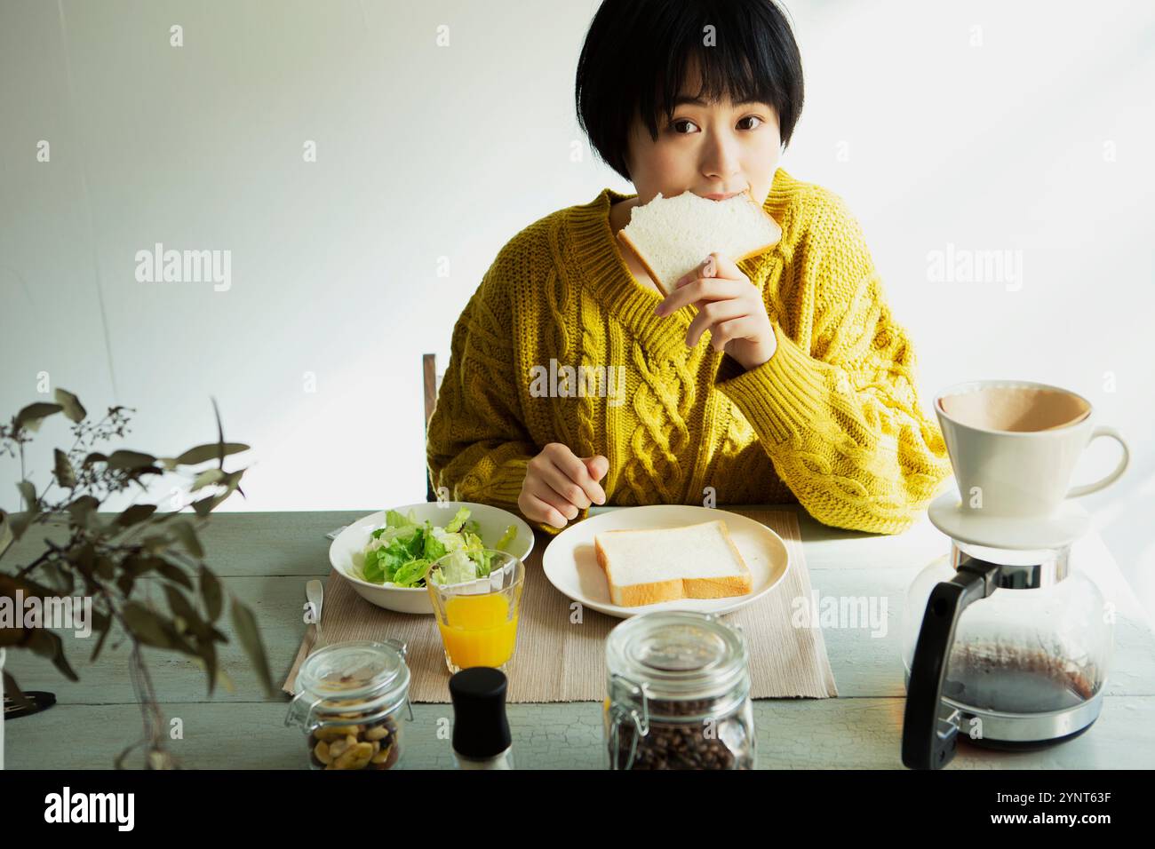 Woman eating bread plain hi-res stock photography and images - Alamy