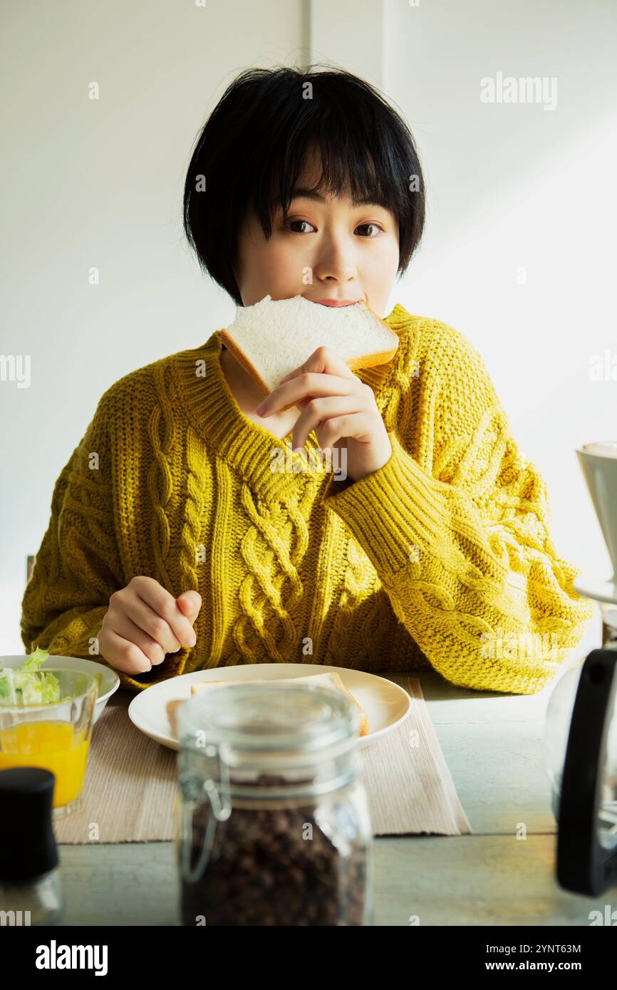 Woman eating bread plain hi-res stock photography and images - Alamy
