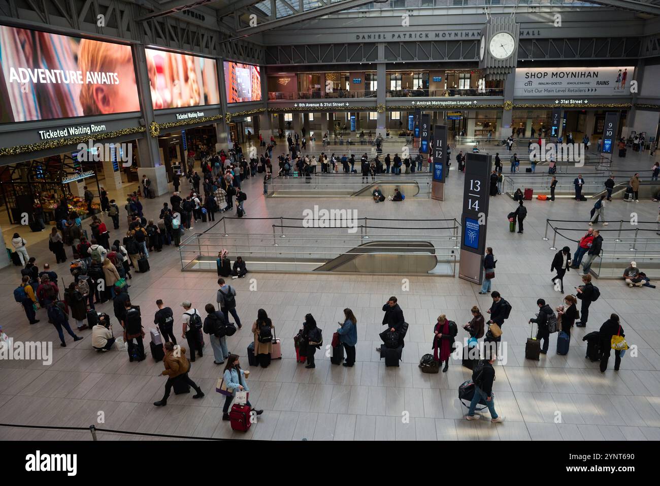 New York, New York, USA. 26th Nov, 2024. Travelers stand in line that ...