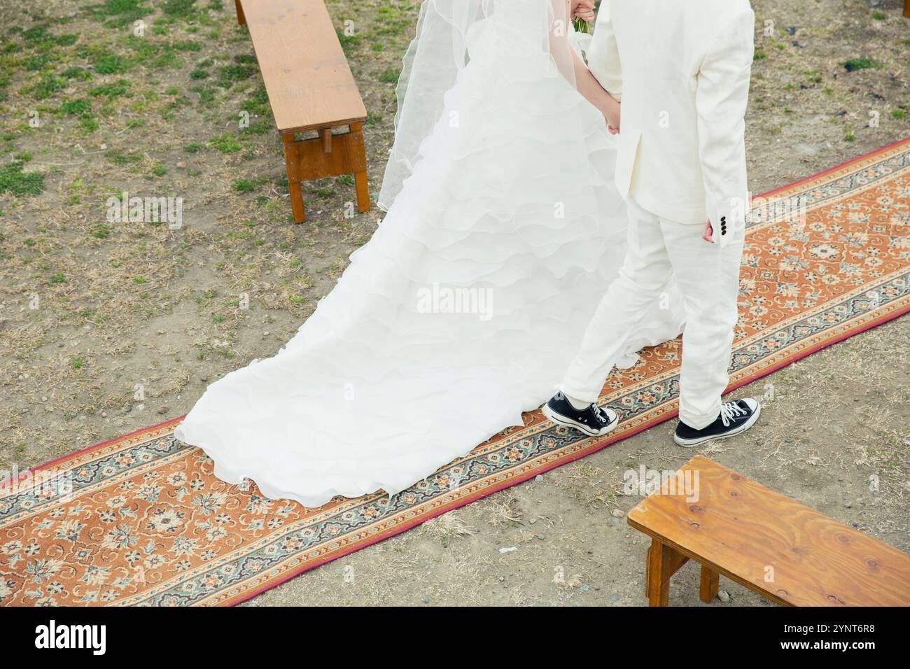 Back view of bride and groom walking down aisle Stock Photo - Alamy