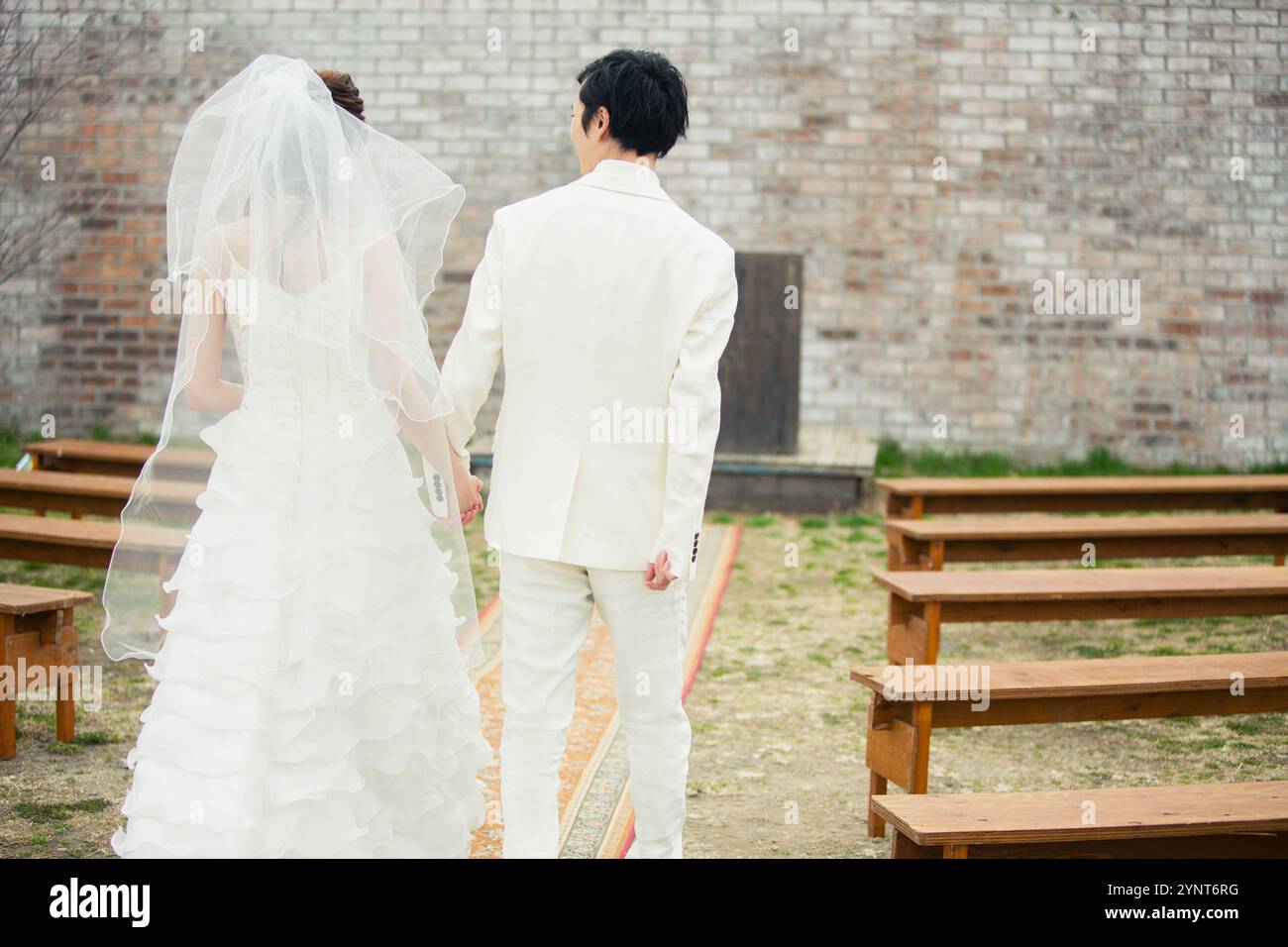 Back view of bride and groom walking down aisle Stock Photo - Alamy