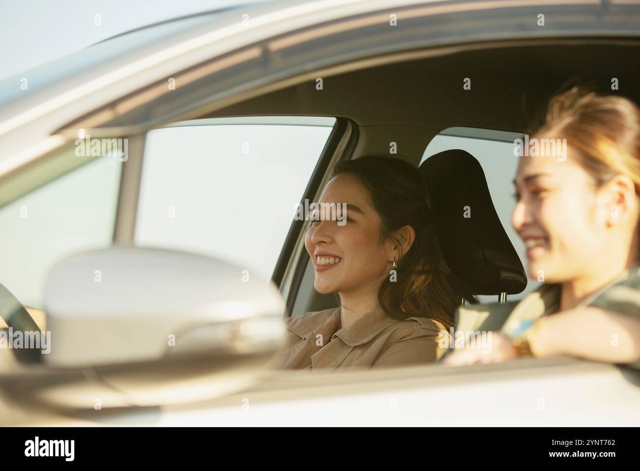 Two women in their 20s enjoying a drive Stock Photo - Alamy