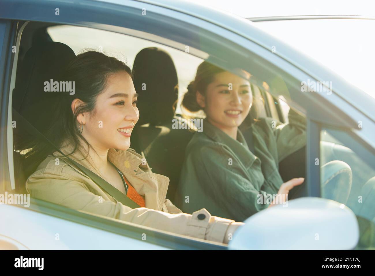 Two women in their 20s enjoying a drive Stock Photo - Alamy