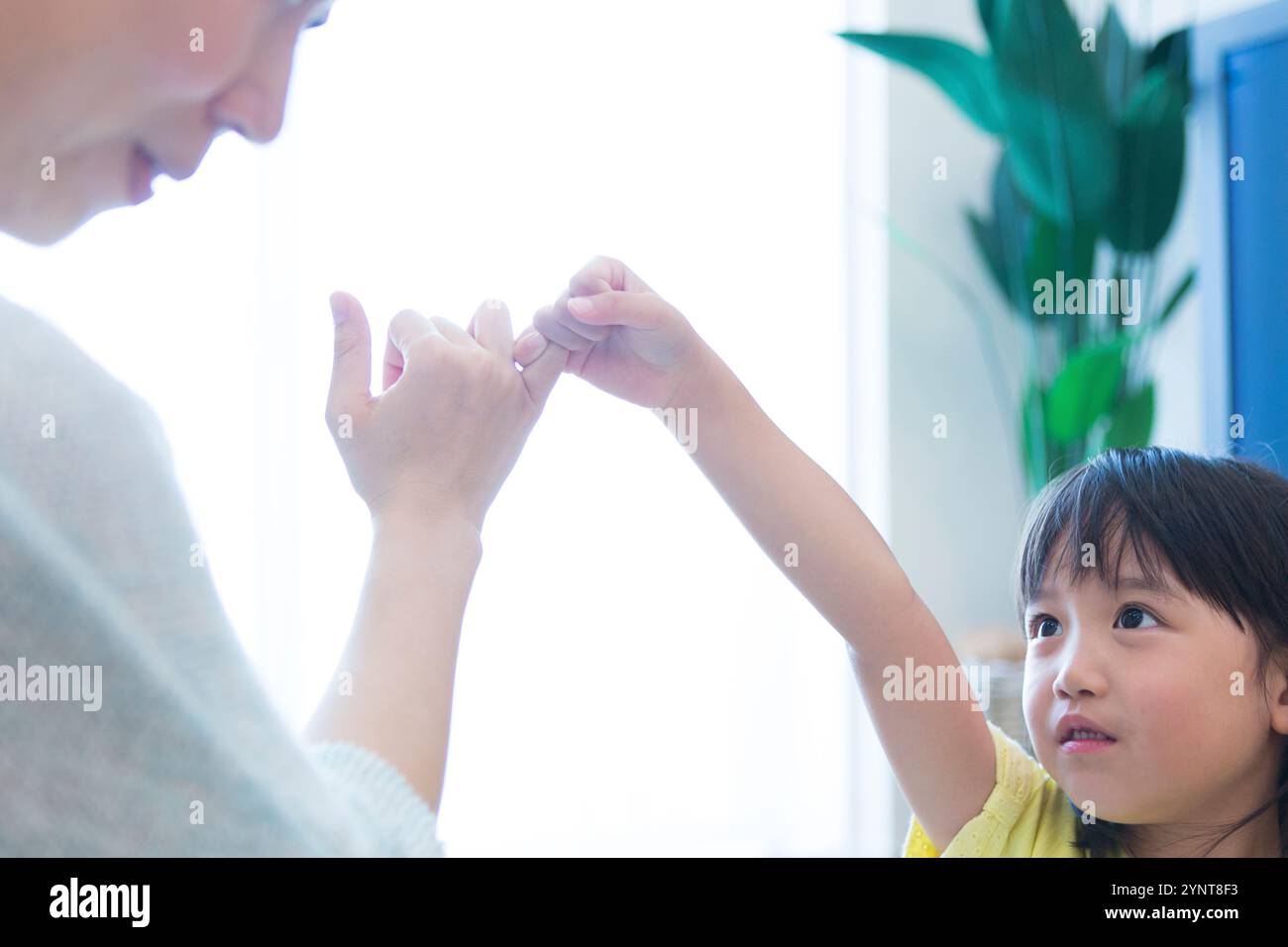 Parents and children doing a finger-slicing manoeuvre Stock Photo - Alamy