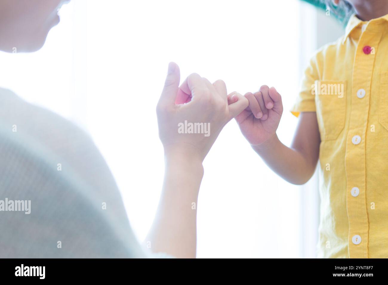 Parents and children doing a finger-slicing manoeuvre Stock Photo - Alamy
